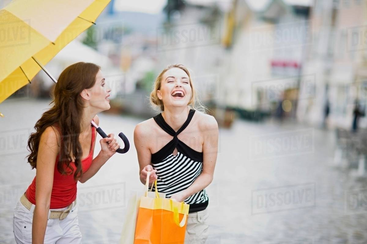 Girls having fun in the rain - Royalty-free Stock Photo | Dissolve