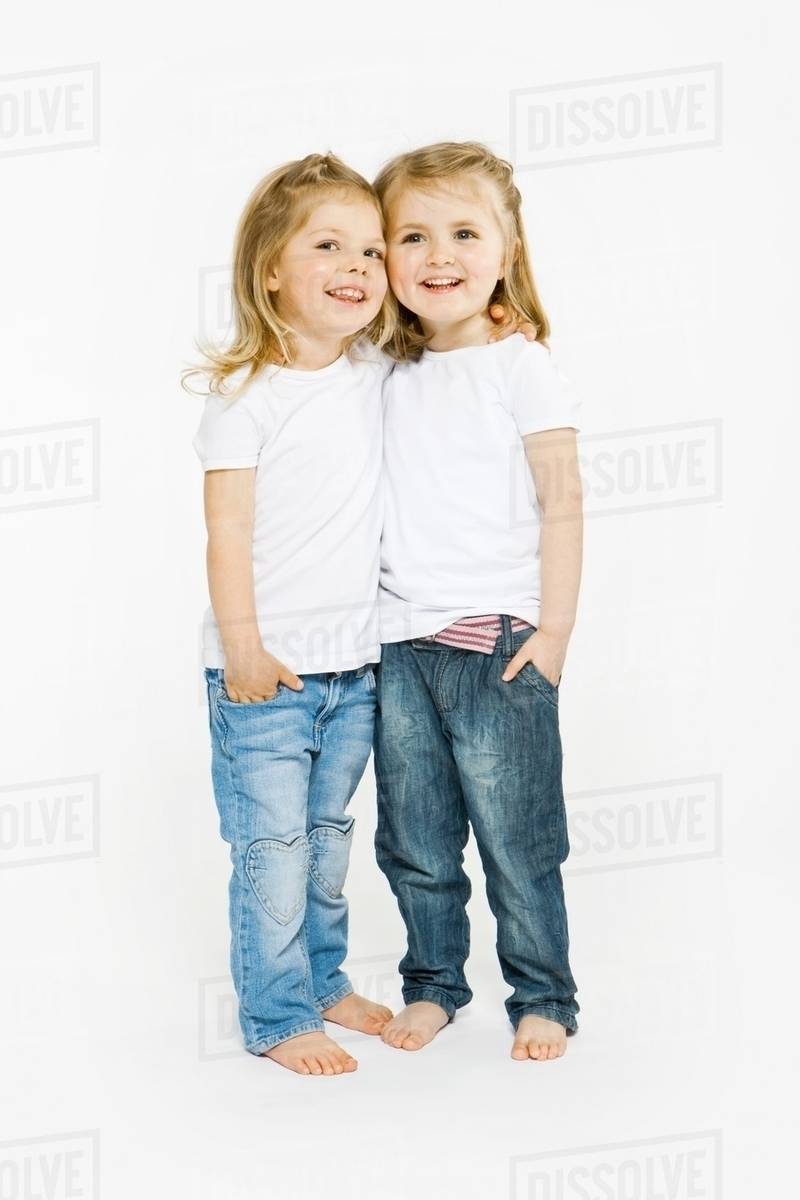 Two toddler girls hugging - Stock Photo - Dissolve