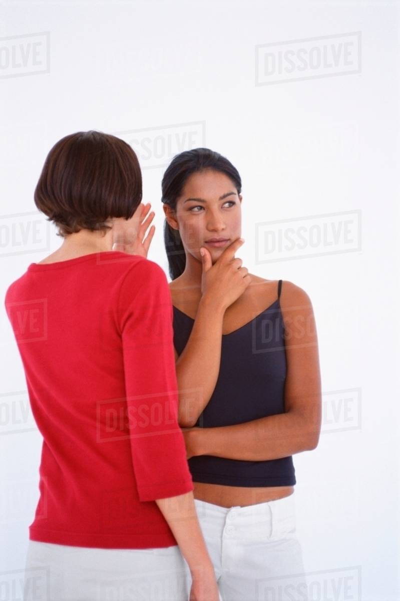Women whispering to each other - Royalty-free Stock Photo | Dissolve