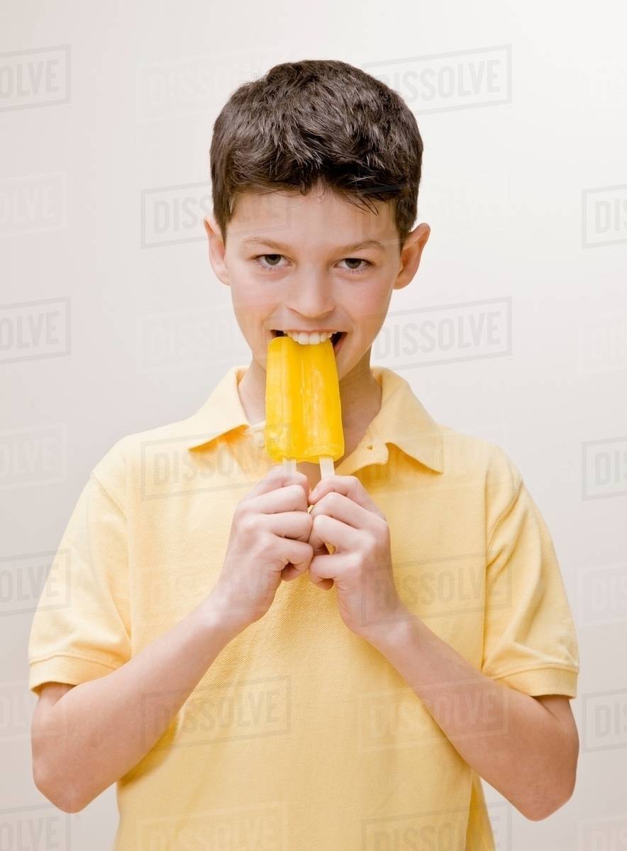 Boy eating a popsicle - Royalty-free Stock Photo | Dissolve