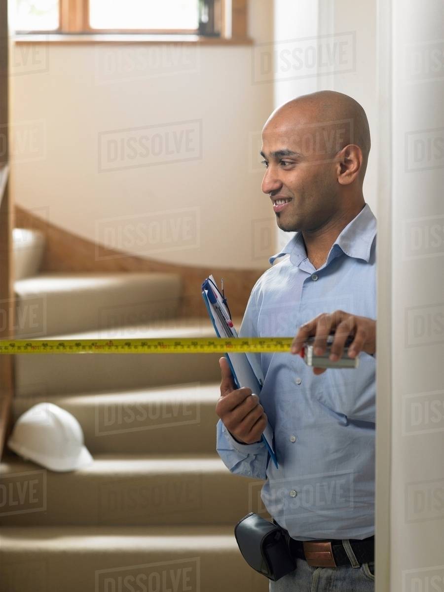 Man measuring hallway - Royalty-free Stock Photo | Dissolve