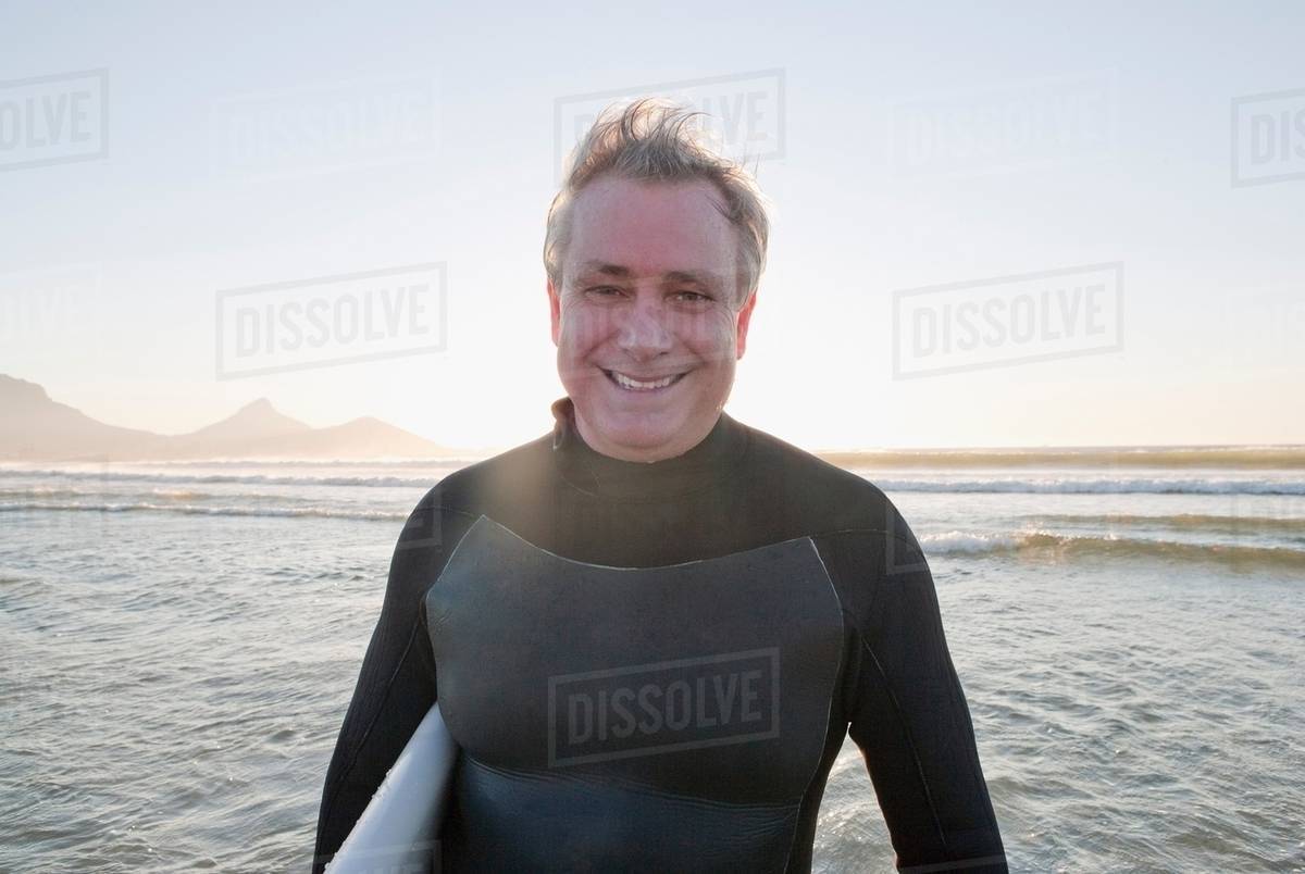 Smiling surfer in water - Stock Photo - Dissolve