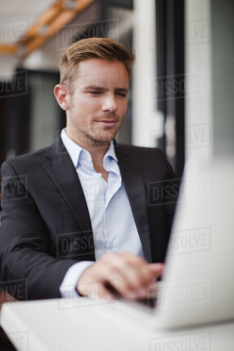 Businessman using laptop - Royalty-free Stock Photo | Dissolve