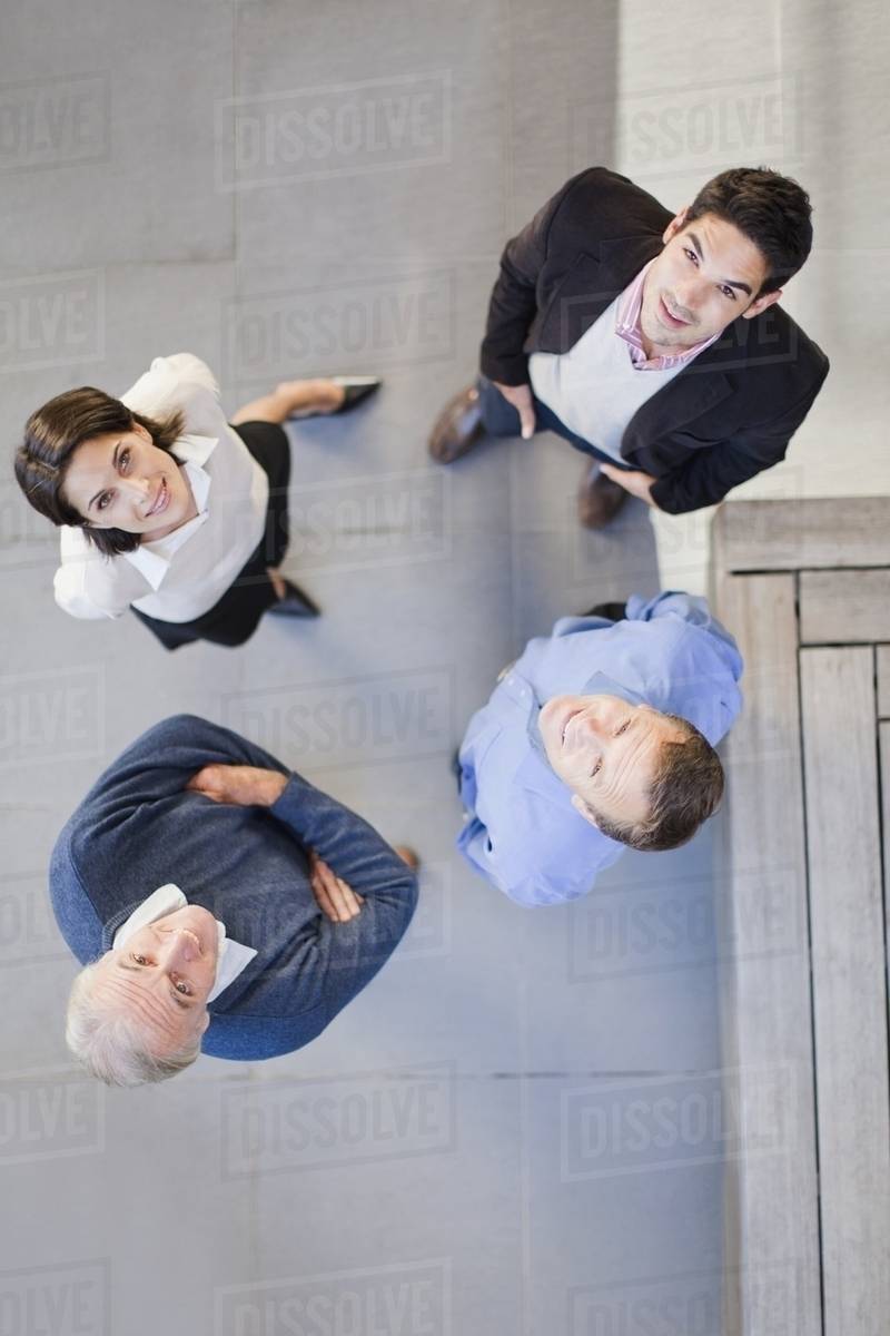 Overhead view of business people talking - Stock Photo - Dissolve