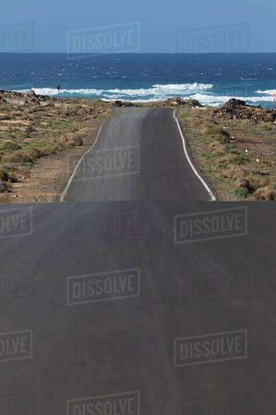 Paved road leading to beach - Royalty-free Stock Photo | Dissolve