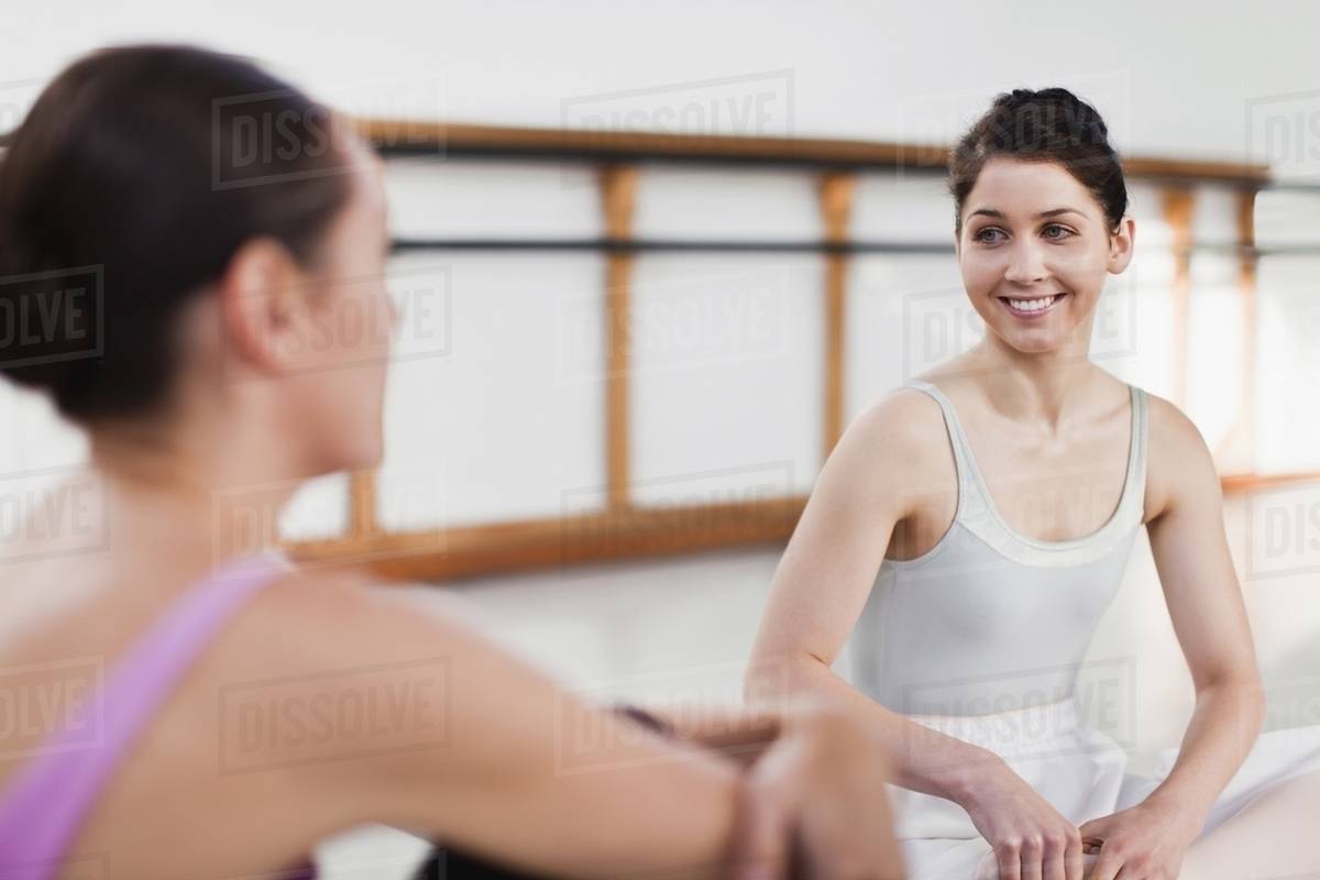 Ballet dancers talking in studio - Royalty-free Stock Photo | Dissolve