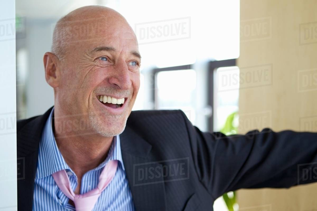 Laughing businessman in loose tie - Royalty-free Stock Photo | Dissolve