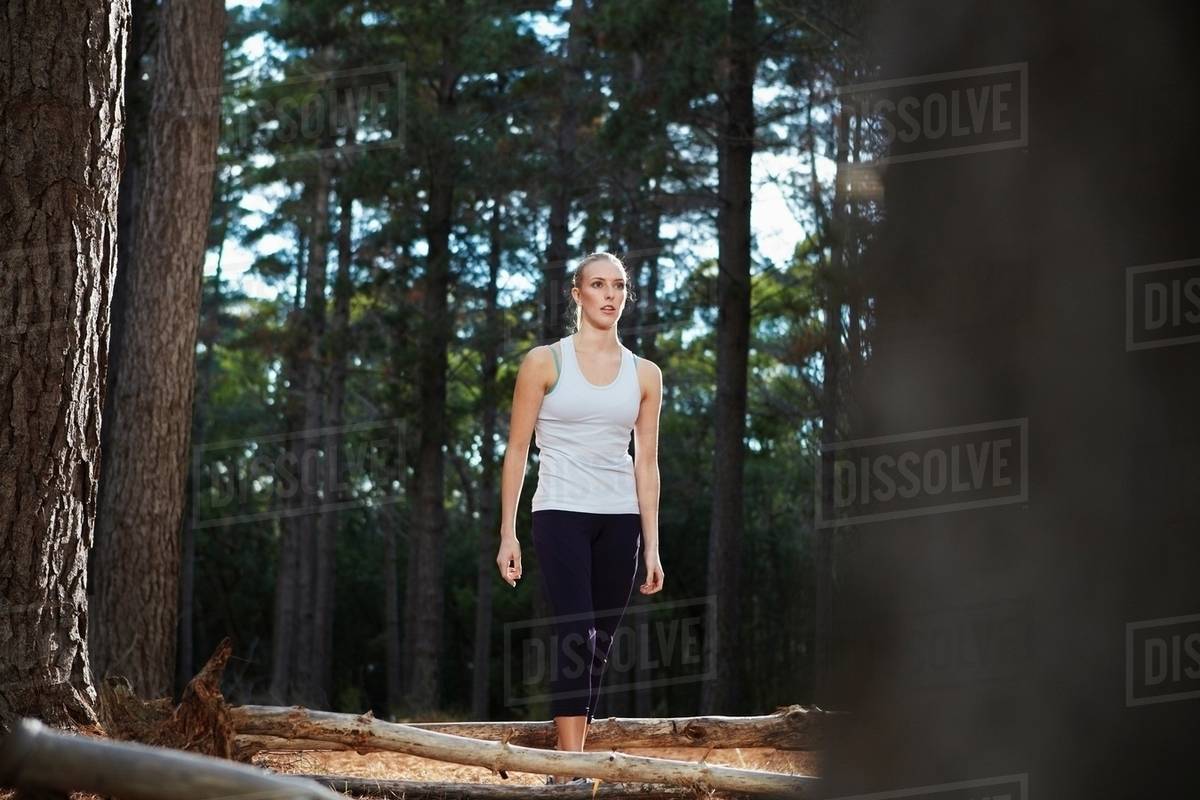 Woman walking in forest - Royalty-free Stock Photo | Dissolve