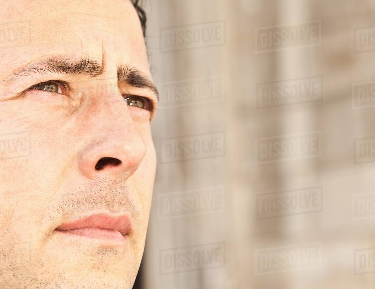 Close up of businessman's serious face - Stock Photo - Dissolve