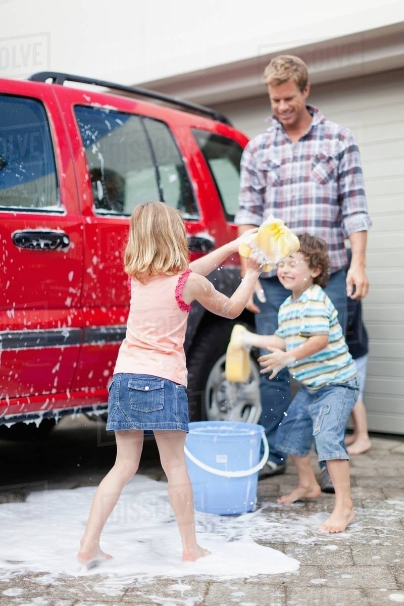 Family washing car together - Royalty-free Stock Photo | Dissolve