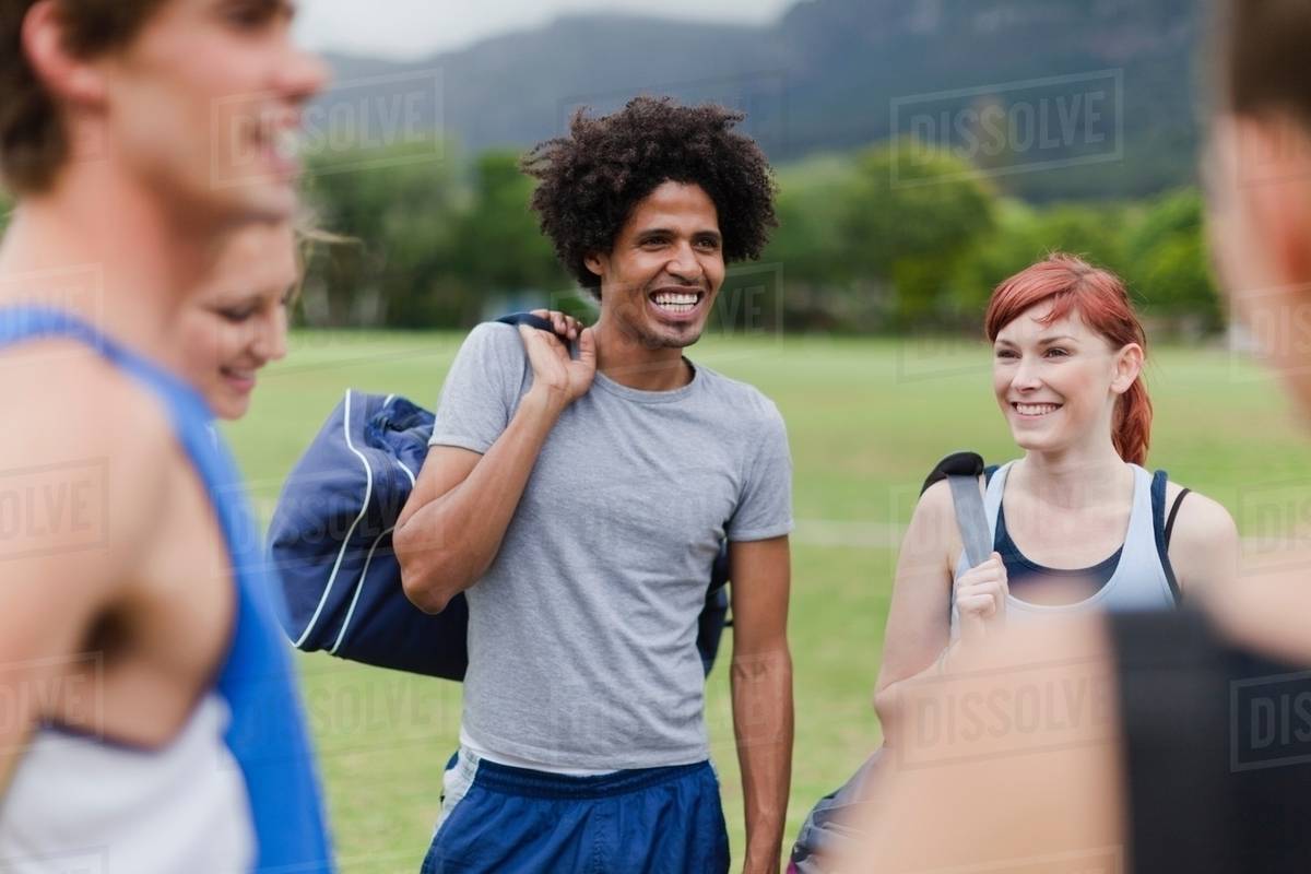 Runners talking in park - Royalty-free Stock Photo | Dissolve