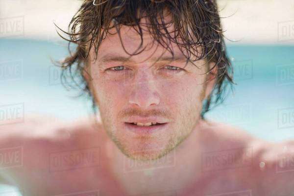 Close up of mans face in pool - Stock Photo - Dissolve
