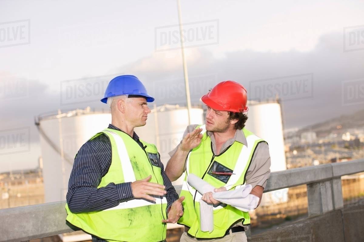 Construction workers talking on site - Royalty-free Stock Photo | Dissolve