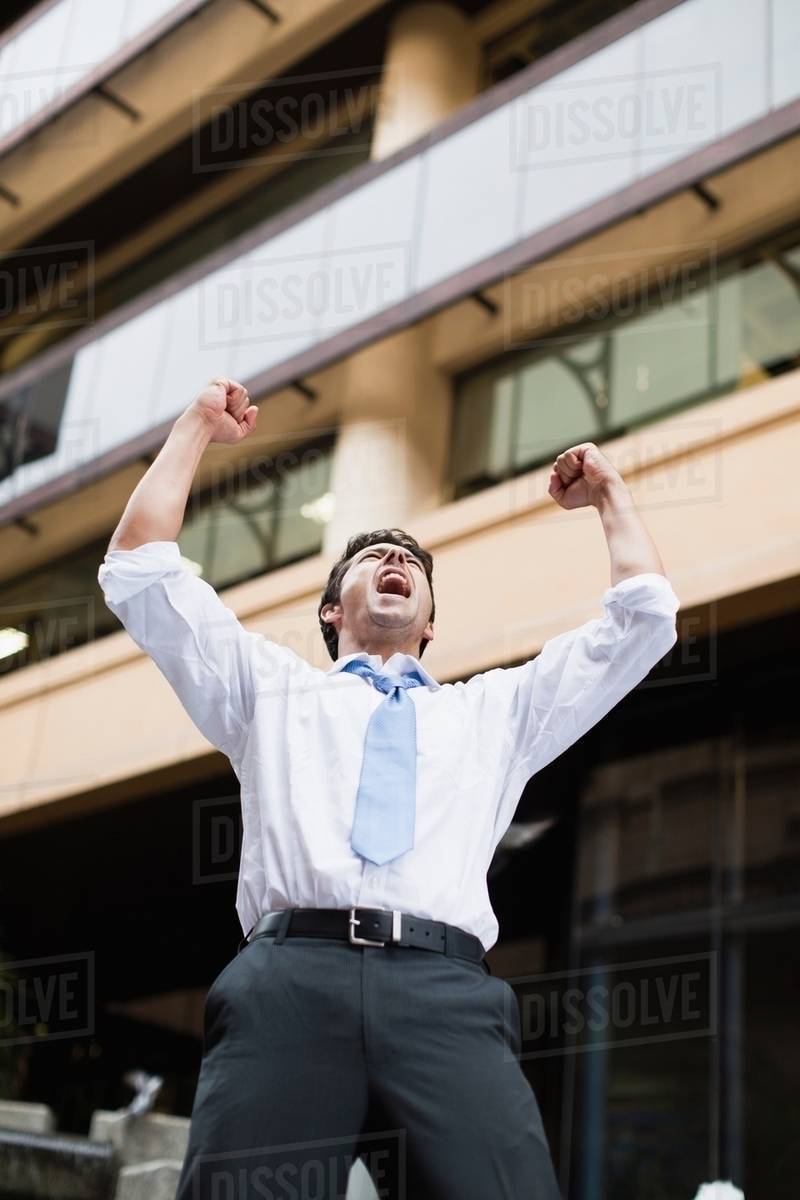 Businessman shouting on city street - Stock Photo - Dissolve