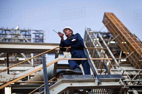 Worker using walkie talkie on site - Royalty-free Stock Photo | Dissolve