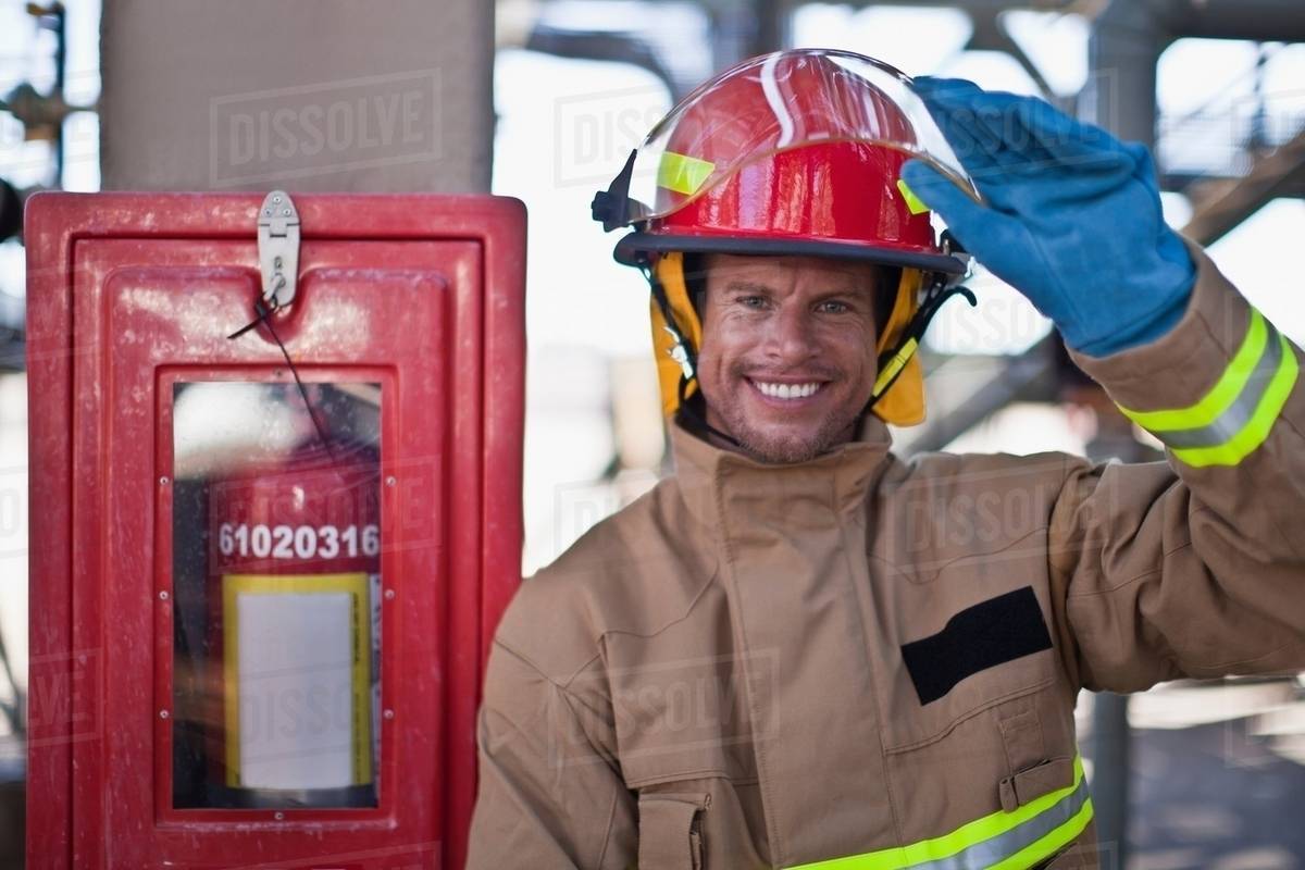 Firefighter smiling on site - Royalty-free Stock Photo | Dissolve