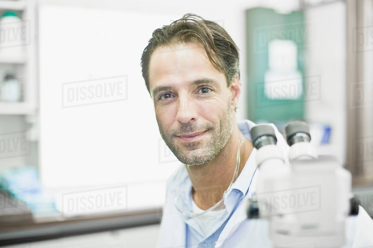 Scientist smiling in lab - Royalty-free Stock Photo | Dissolve