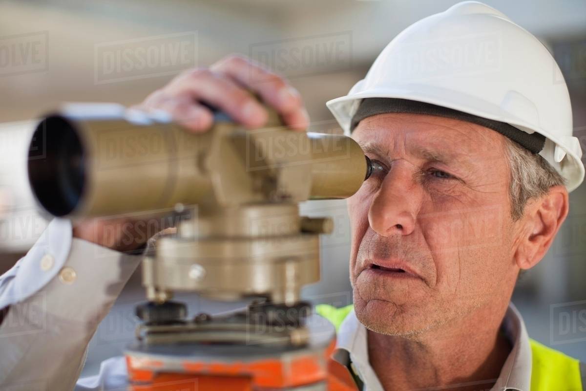 Worker using equipment on site - Royalty-free Stock Photo | Dissolve