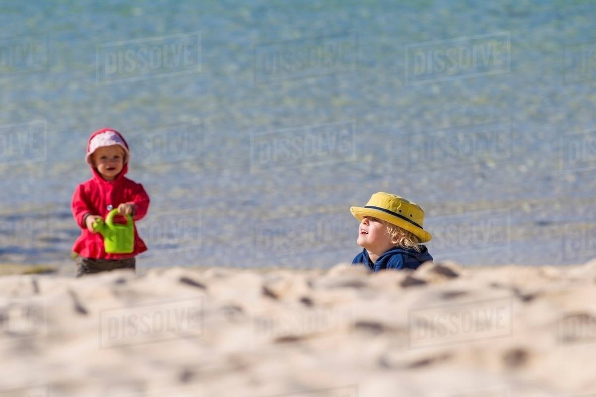 Children playing on sandy beach - Royalty-free Stock Photo | Dissolve