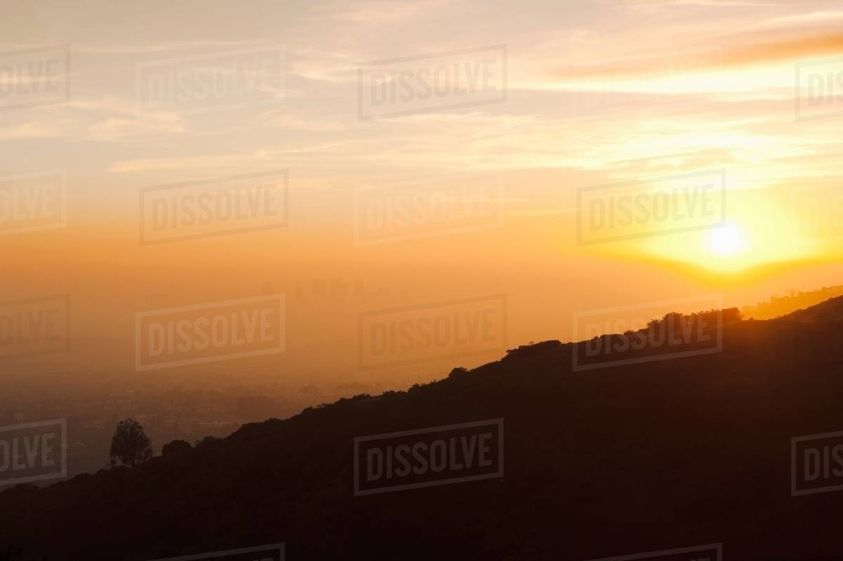 Silhouette of hillside at sunset - Stock Photo - Dissolve