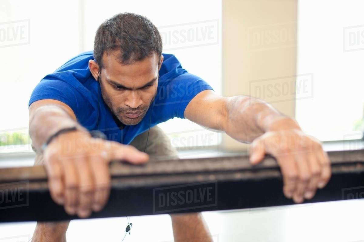 Man stretching in gym - Royalty-free Stock Photo | Dissolve