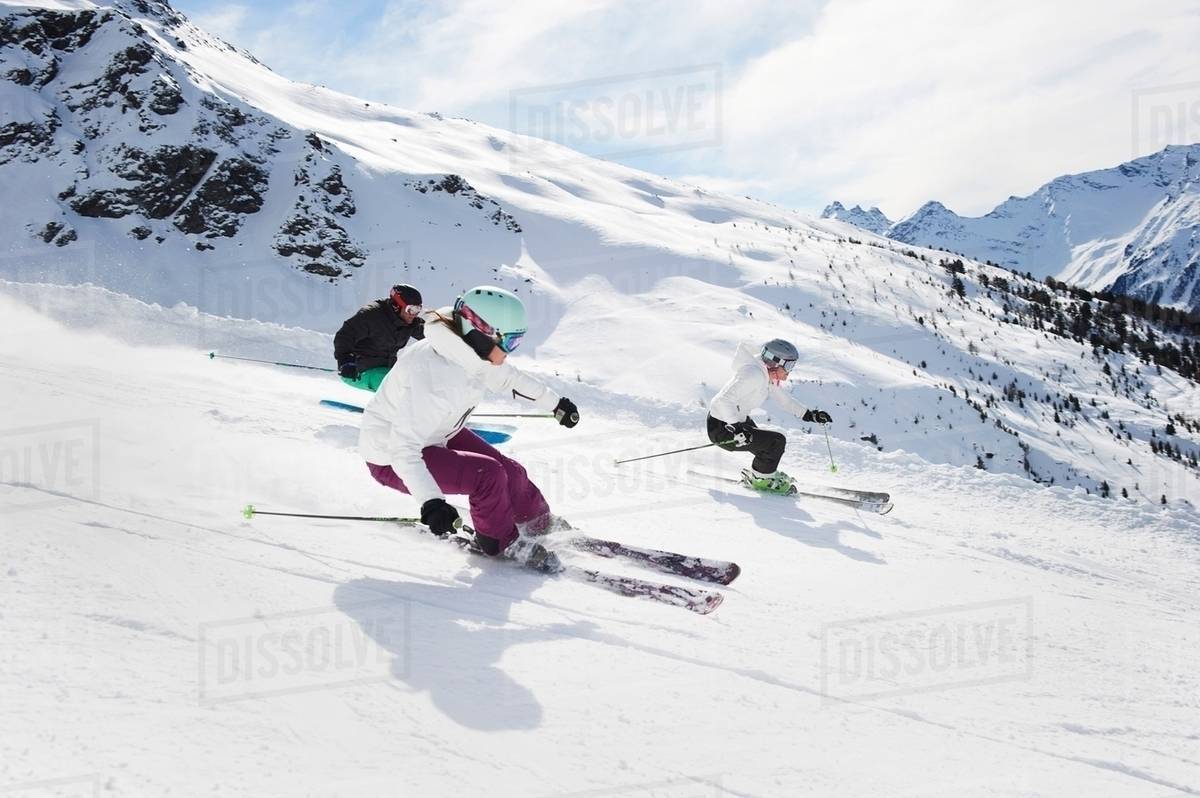 Skiers skiing together on slope - Royalty-free Stock Photo | Dissolve