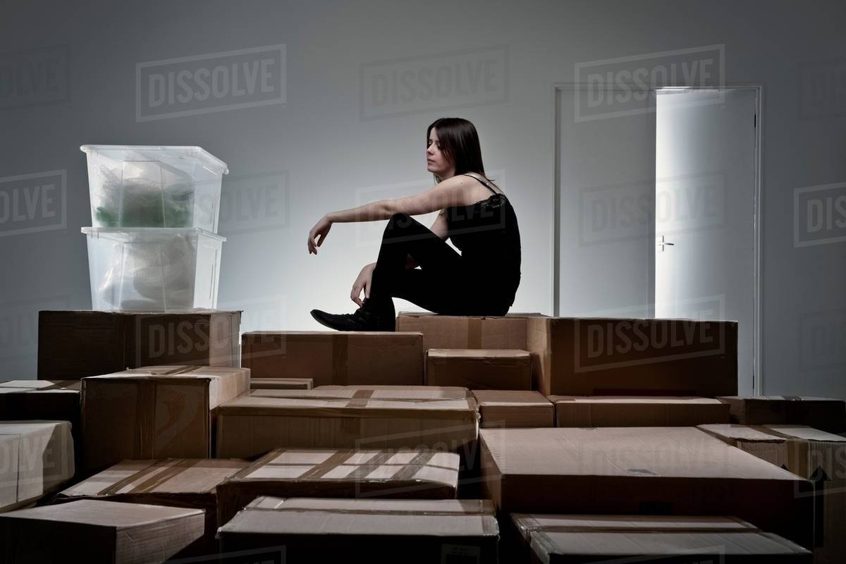 Teenage girl sitting on cardboard boxes - Royalty-free Stock Photo ...
