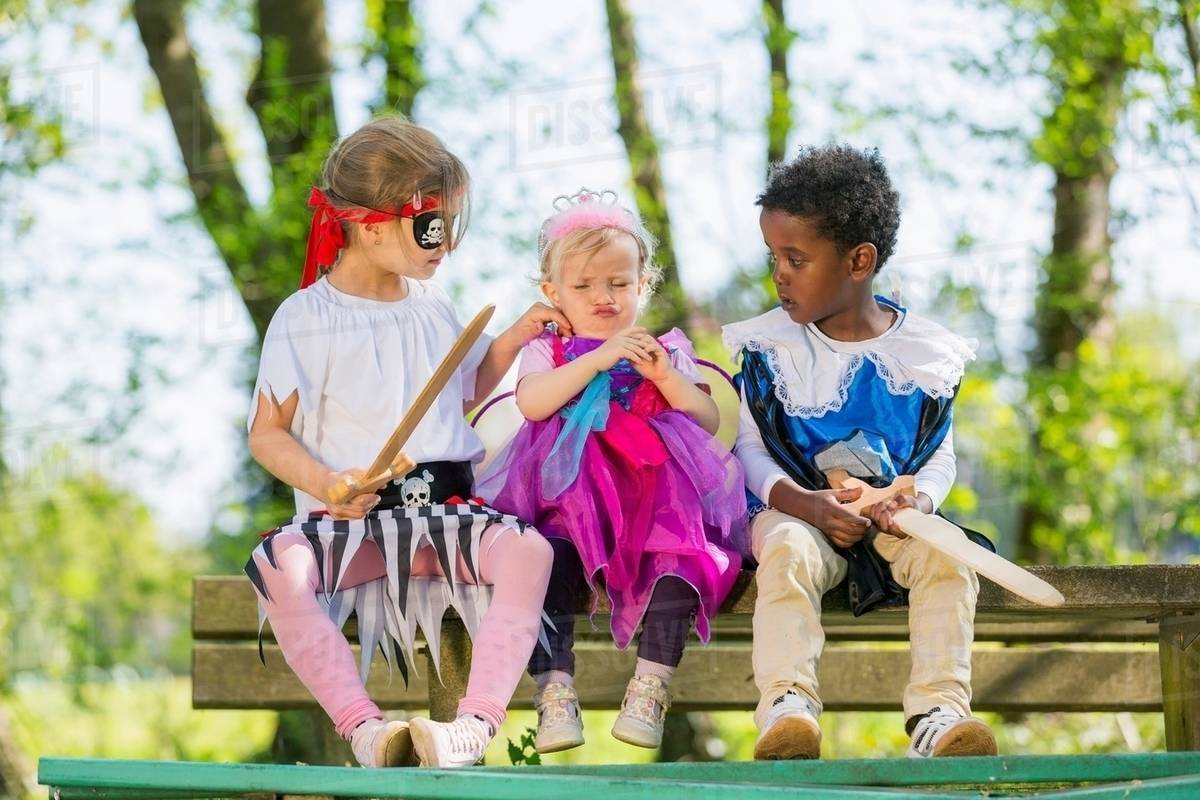 Children playing dress up outdoors - Royalty-free Stock Photo | Dissolve