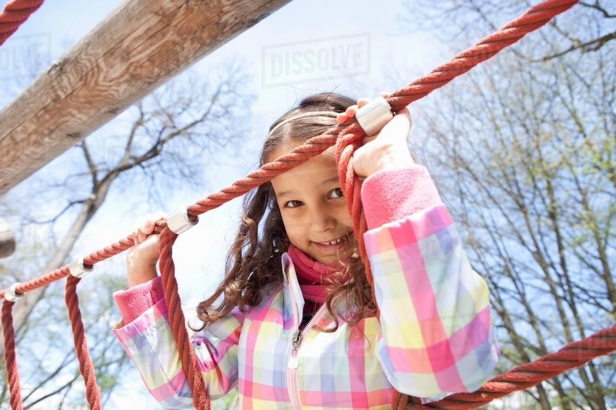 Girl climbing ropes in playground - Royalty-free Stock Photo | Dissolve
