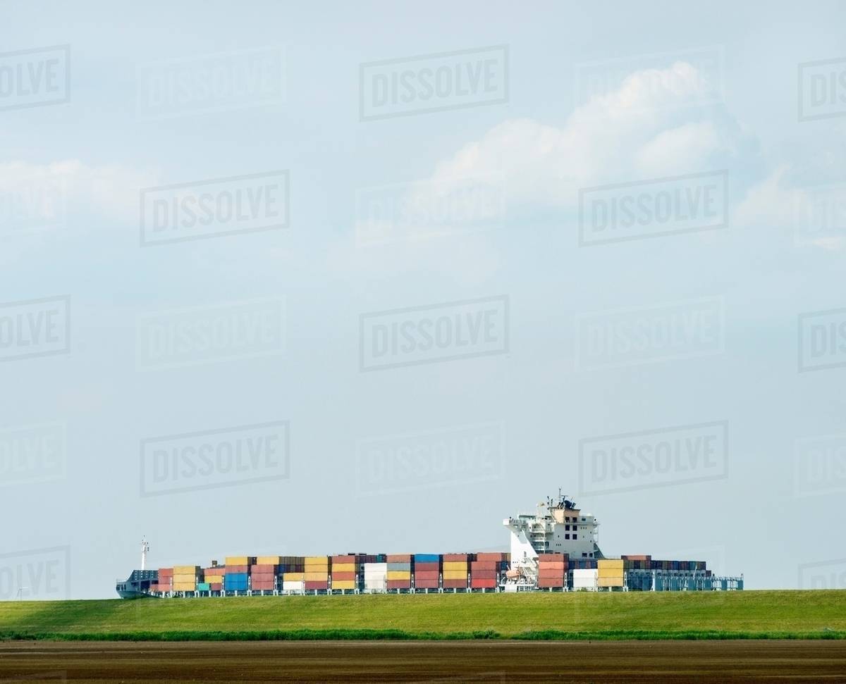 Containers in shipyard by rural field - Stock Photo - Dissolve
