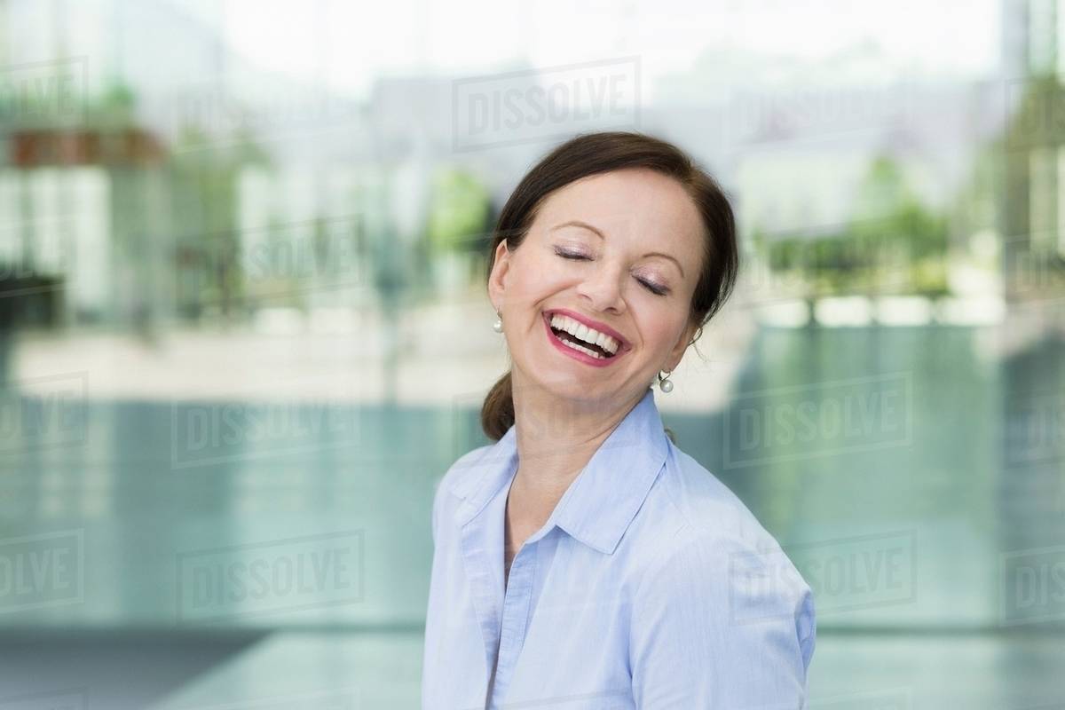 Portrait of smiling mature woman - Royalty-free Stock Photo | Dissolve