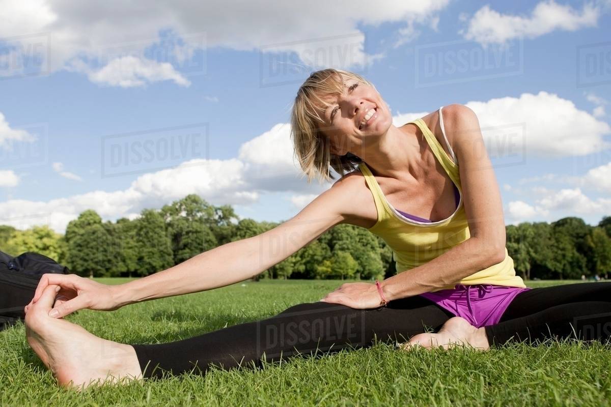 Woman stretching outdoors - Royalty-free Stock Photo | Dissolve