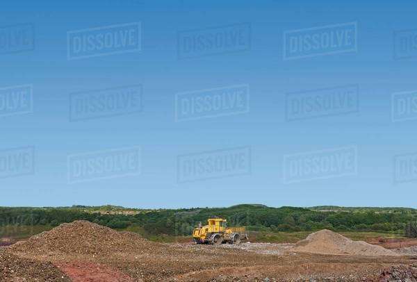 Digger burying waste on landfill site - Royalty-free Stock Photo | Dissolve