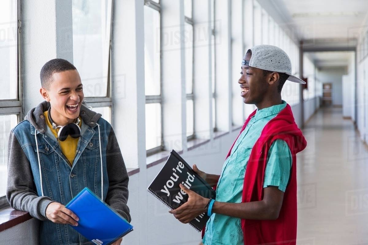 Students standing in hallway, chatting - Royalty-free Stock Photo ...