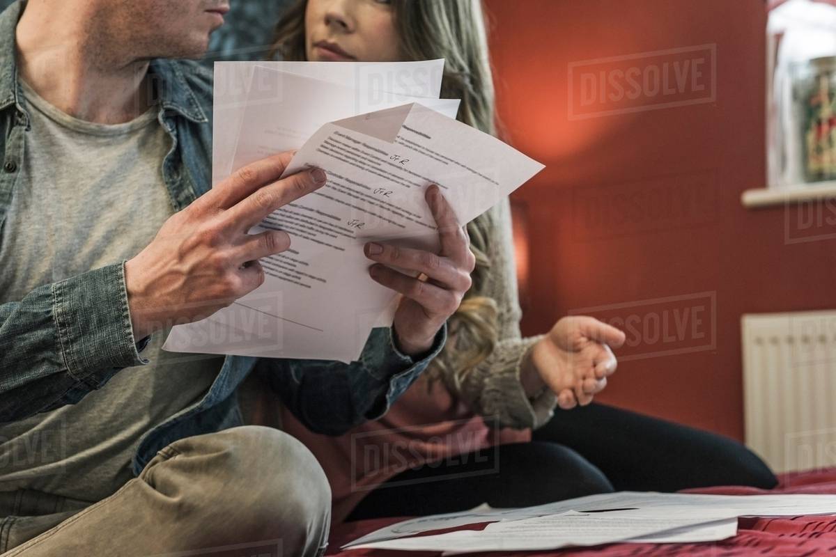 Couple looking at paperwork - Stock Photo - Dissolve