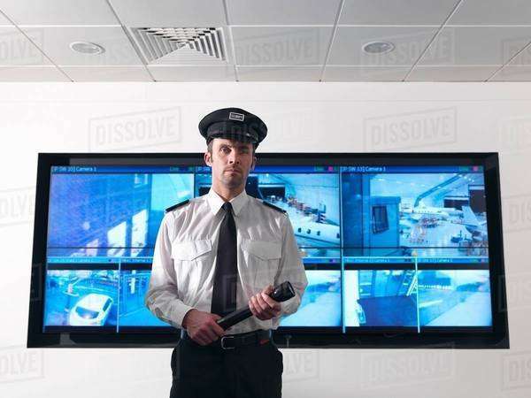 Security guard in control room - Stock Photo - Dissolve