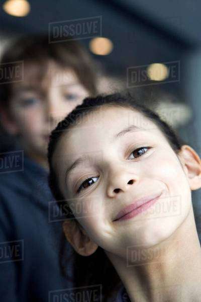 Portrait of 7 years old girl smiling - Stock Photo - Dissolve