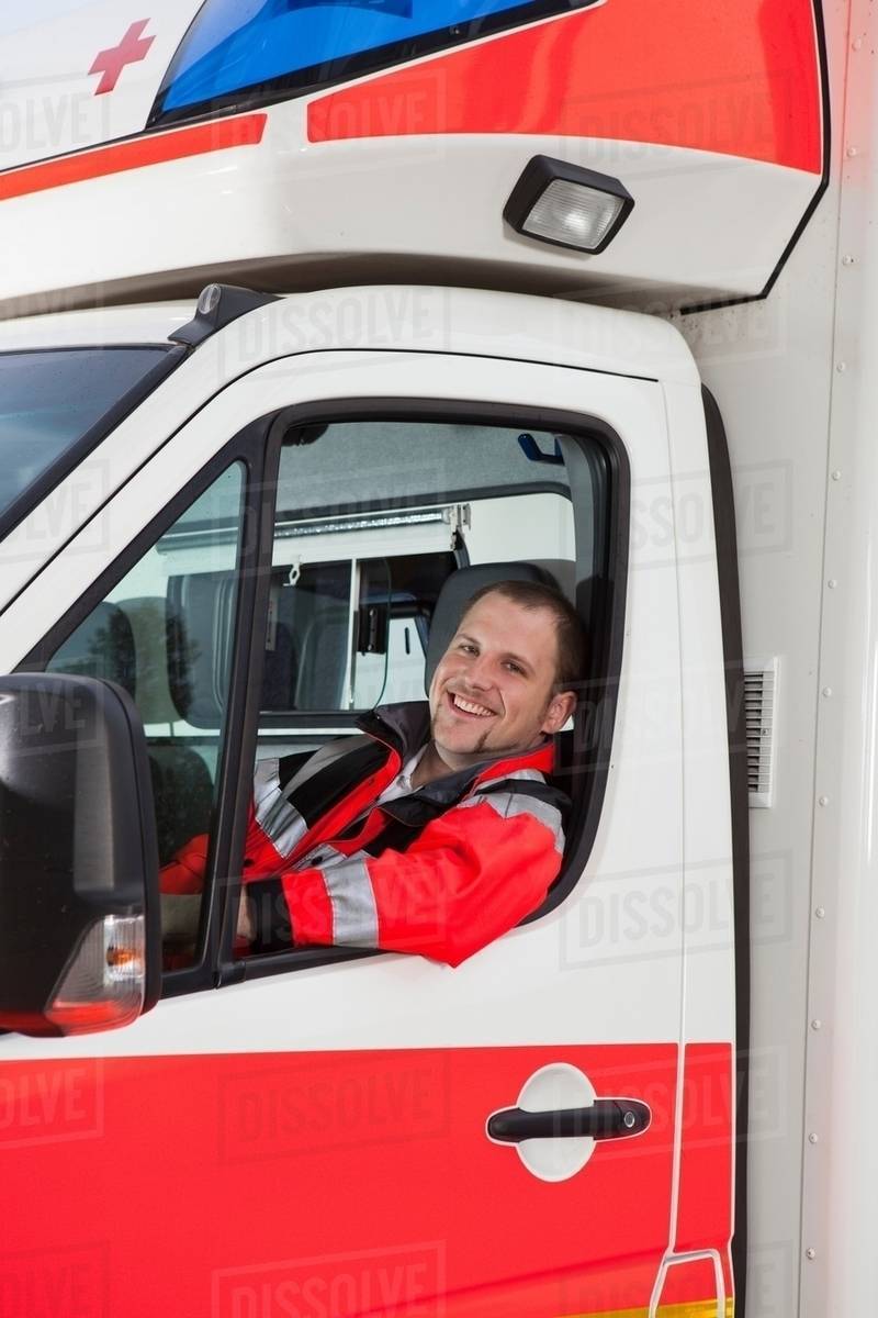 Ambulance man in coach, smiling - Stock Photo - Dissolve