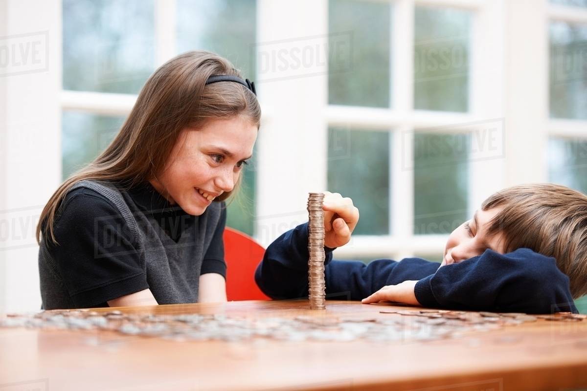 Children counting a pile of money - Stock Photo - Dissolve