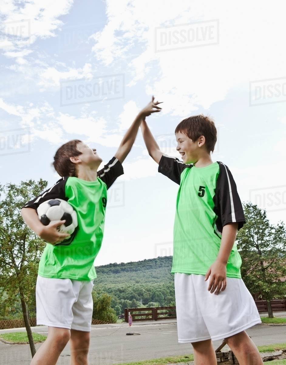 Twin brothers high five - Royalty-free Stock Photo | Dissolve