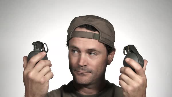 Isolated on white, man catches two grenades, shows them off and gets an ...