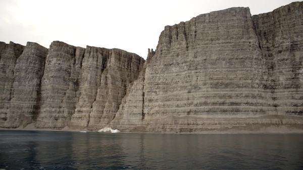 Cliffs towering over the Arctic ocean in Greenland. (Pan) - Stock Video ...