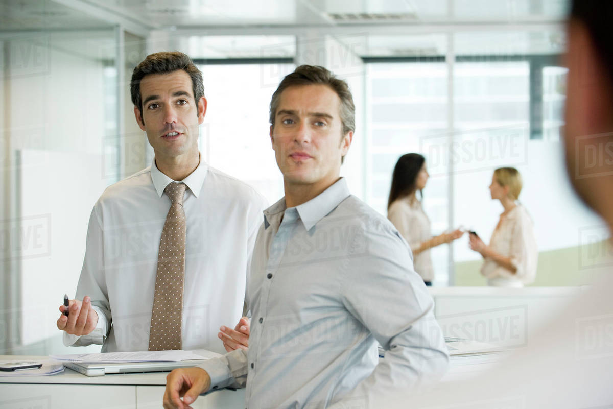 Executives in discussion with colleague - Royalty-free Stock Photo ...