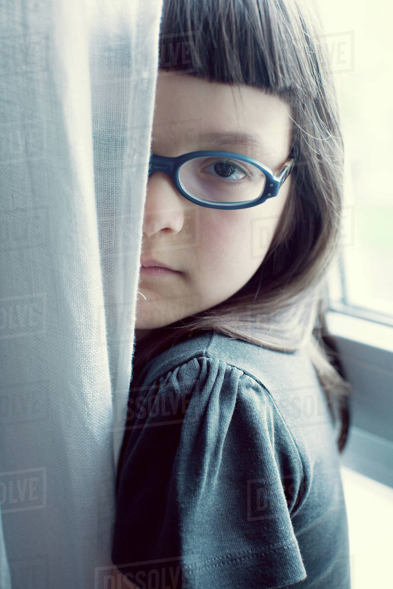 Girl hiding behind curtain - Royalty-free Stock Photo | Dissolve