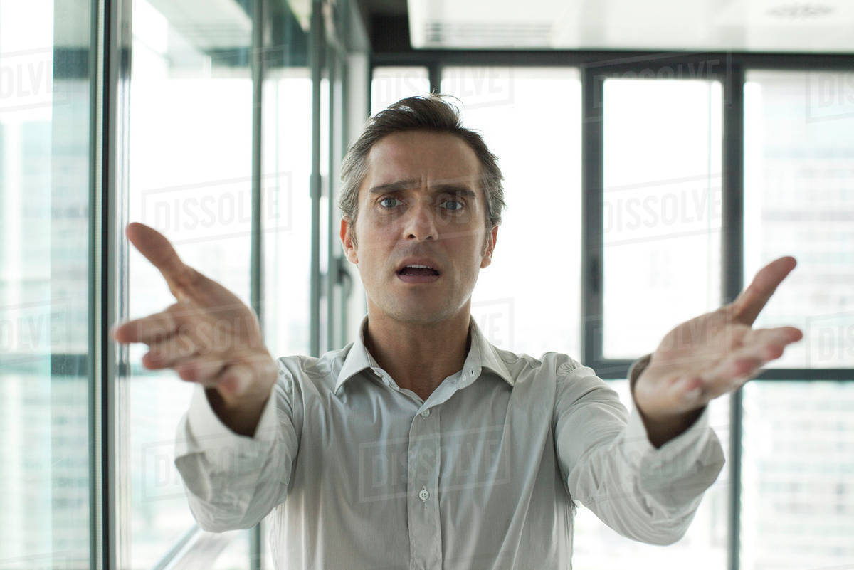 Man Throwing Up Hands In Frustration Stock Photo Dissolve