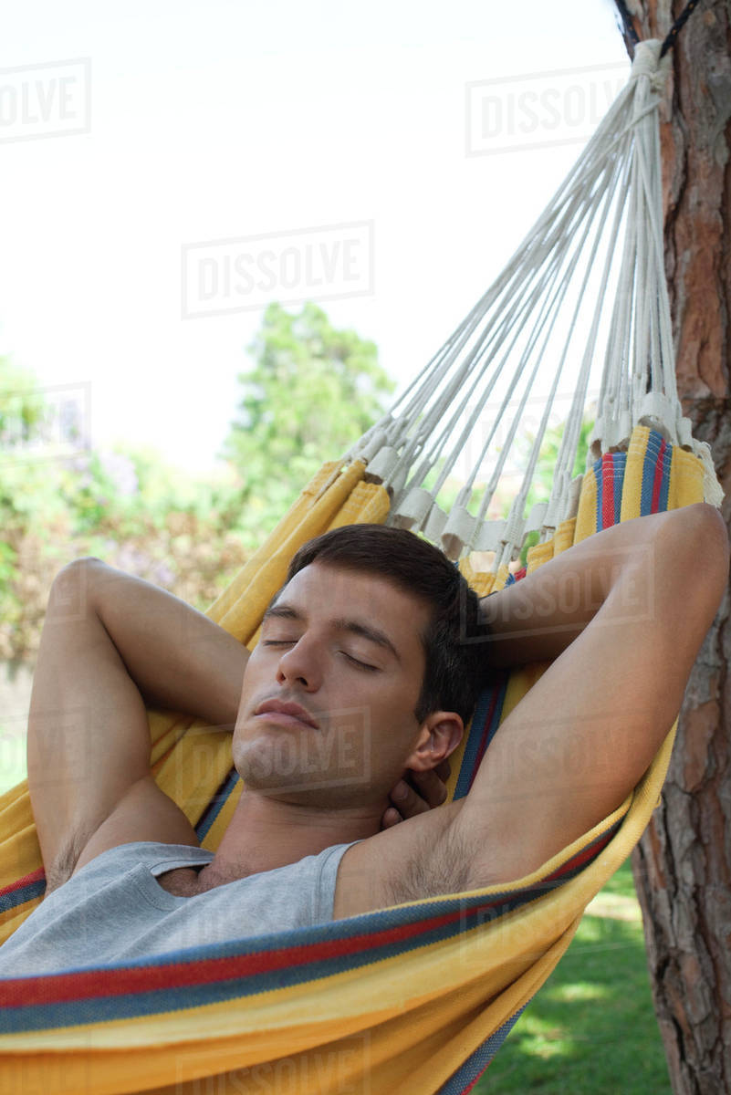 Man napping in hammock - Royalty-free Stock Photo | Dissolve
