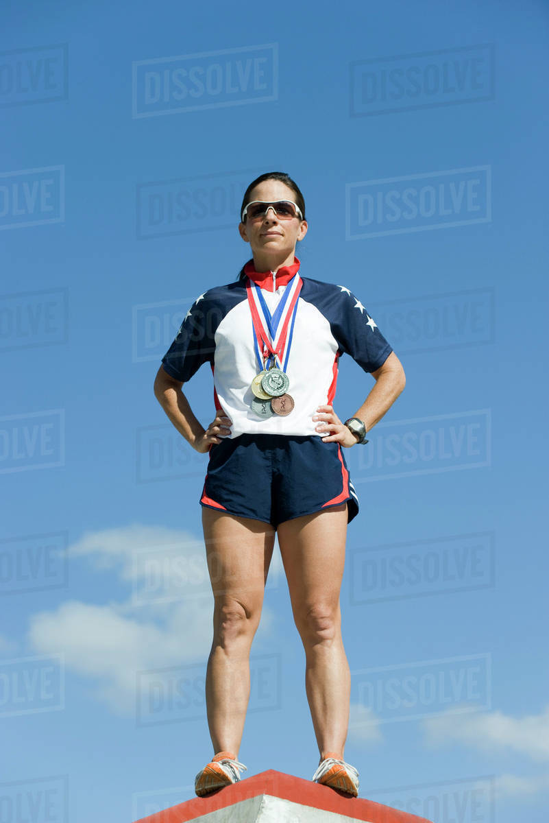 Female athlete standing on winner's podium - Royalty-free Stock Photo ...