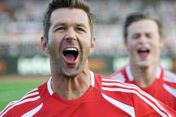 Soccer players shouting in victory - Royalty-free Stock Photo | Dissolve