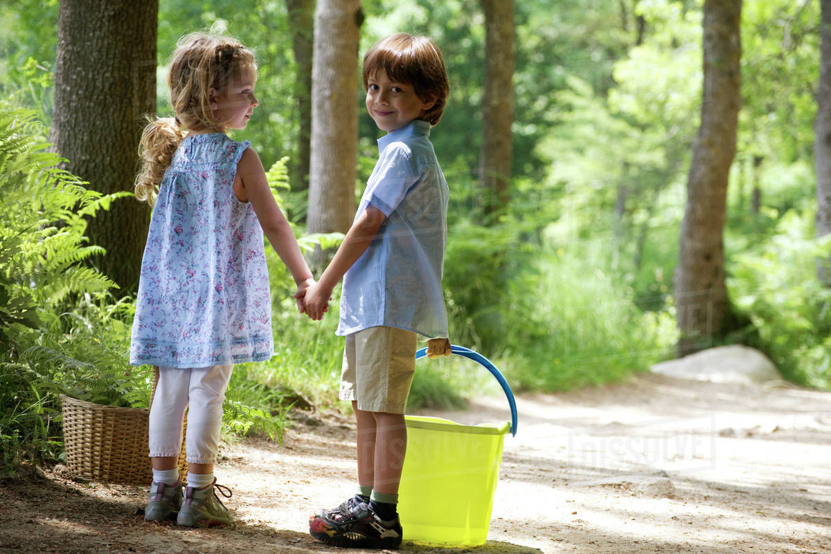 Children holding hands on path in woods - Royalty-free Stock Photo ...