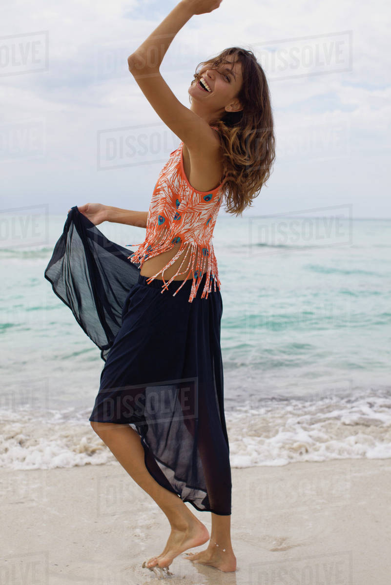 Woman dancing on beach - Royalty-free Stock Photo | Dissolve